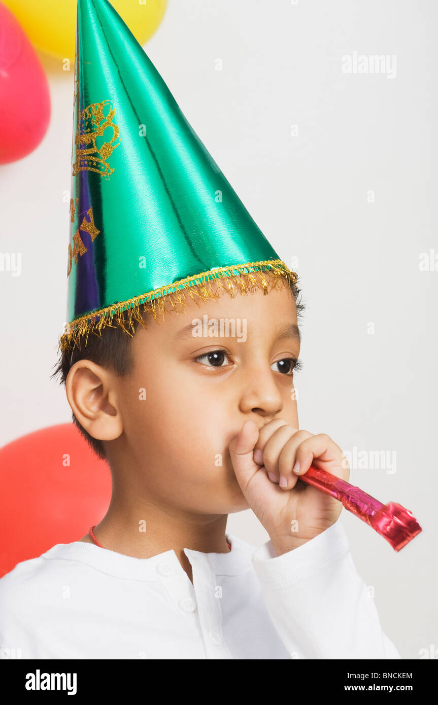Boy blowing party blower hi-res stock photography and images - Alamy