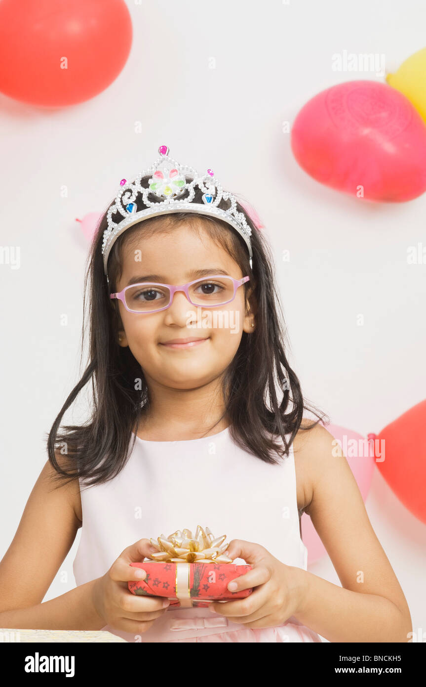 Portrait of a girl holding birthday presents Stock Photo - Alamy