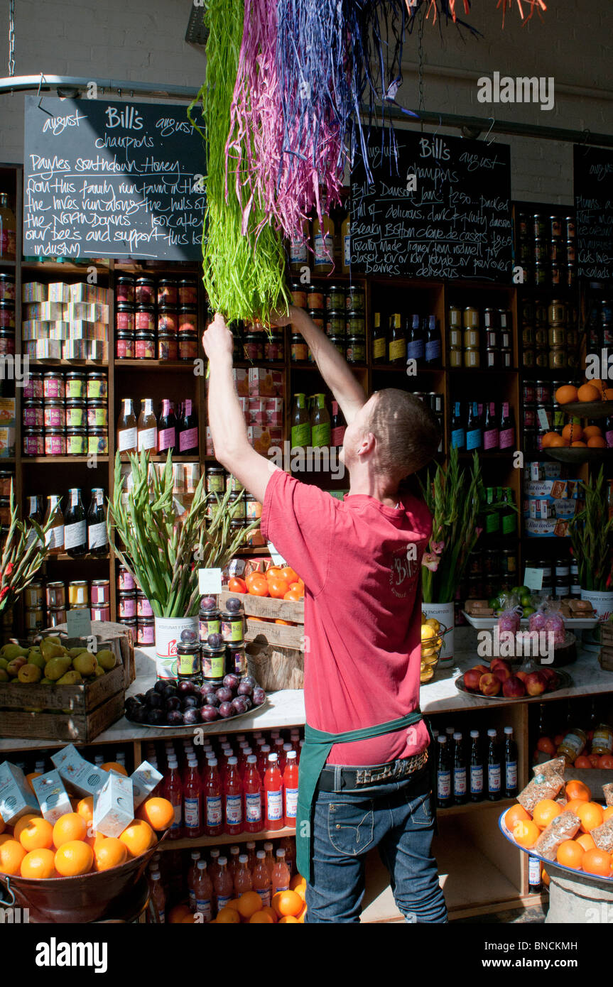 Harry Allan trims the raffia which decorates the food display at Bill's ...