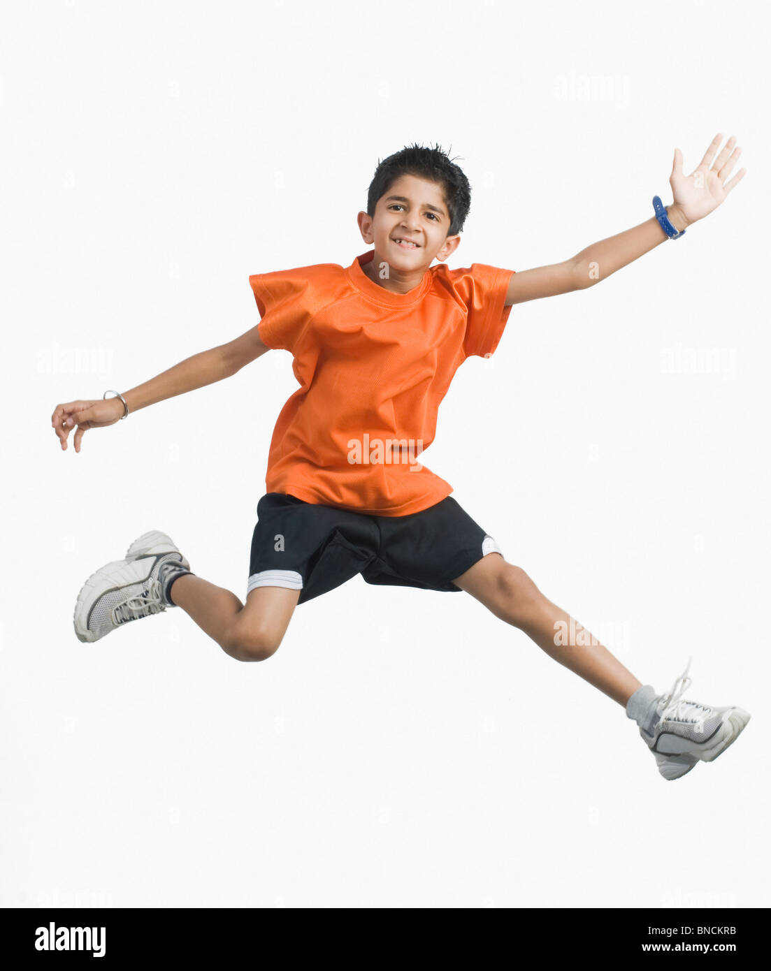 Boy jumping and smiling Stock Photo - Alamy