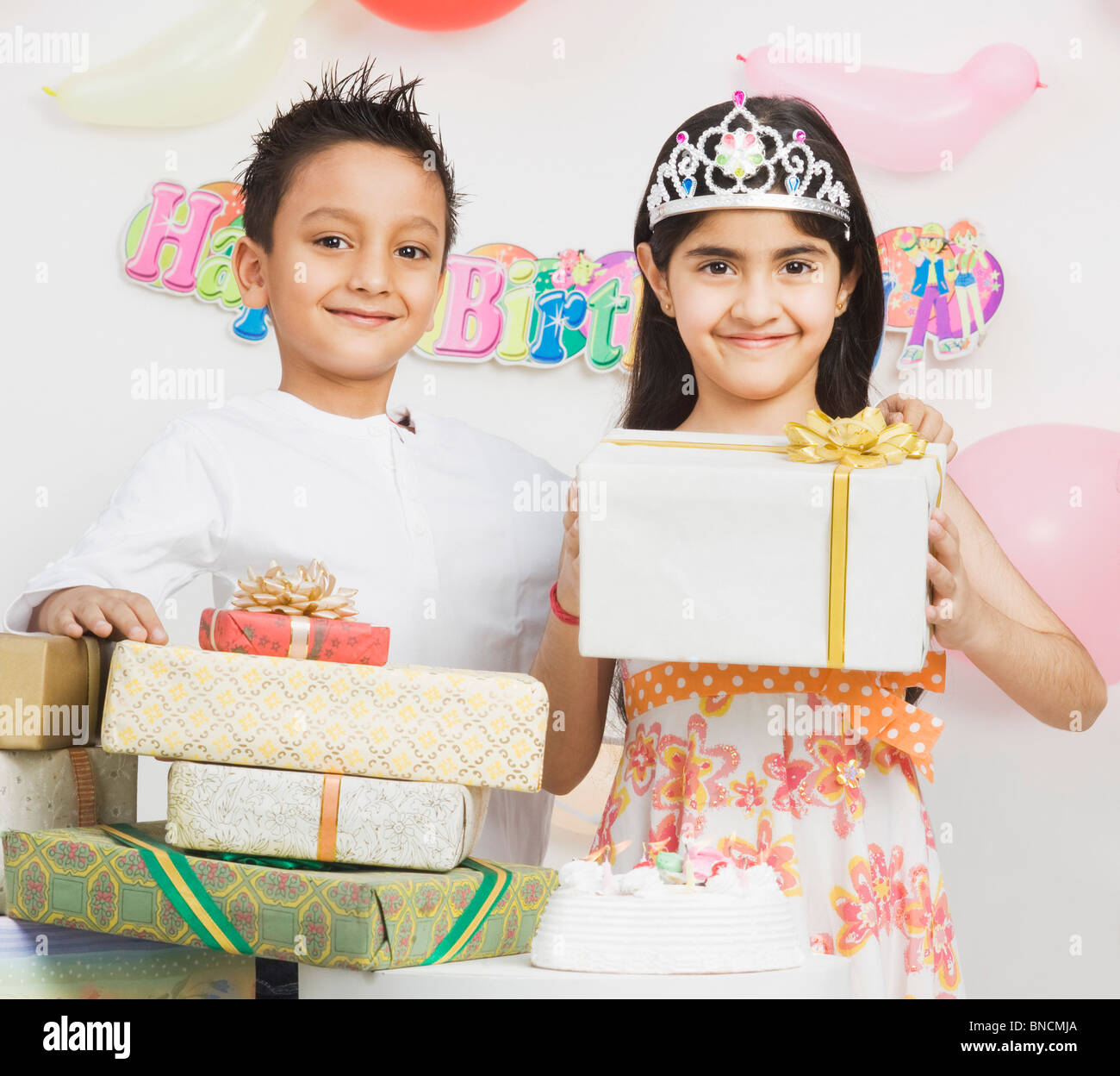 Portrait of a girl and a boy with birthday presents Stock Photo - Alamy