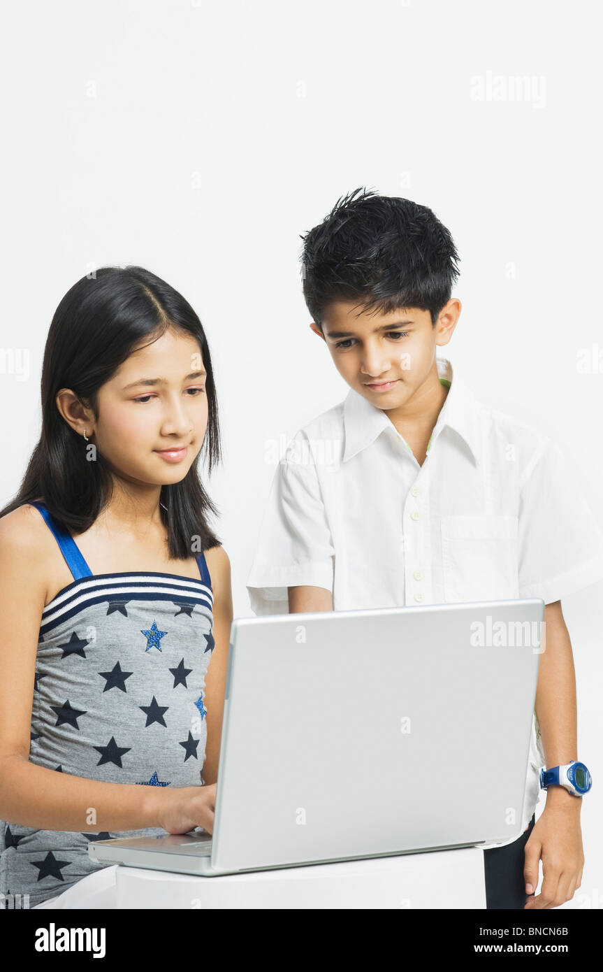Girl and a boy working on a laptop Stock Photo - Alamy