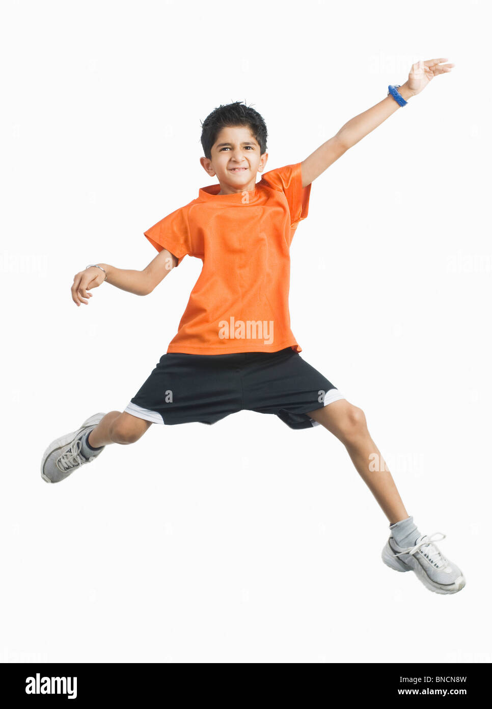 Portrait of a boy jumping and smiling Stock Photo - Alamy