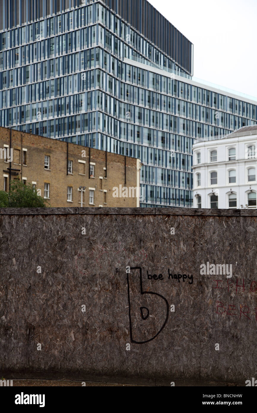 bee Happy graffiti on brick wall with Blue Fin building in background ...