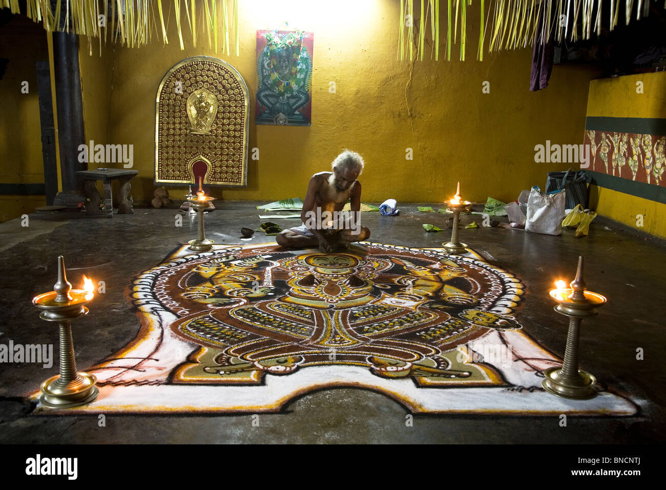 A Namboodiri Brahmin priest completes a Kalam floor image of the Hindu ...