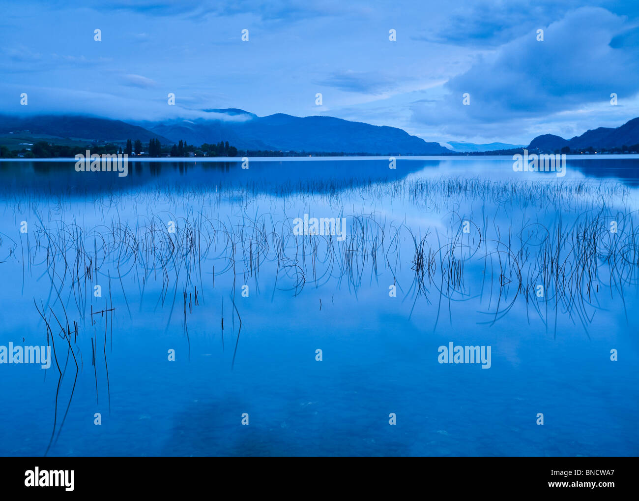 Osoyoos Lake surrounded by misty mountains at twilight. Haynes Point ...
