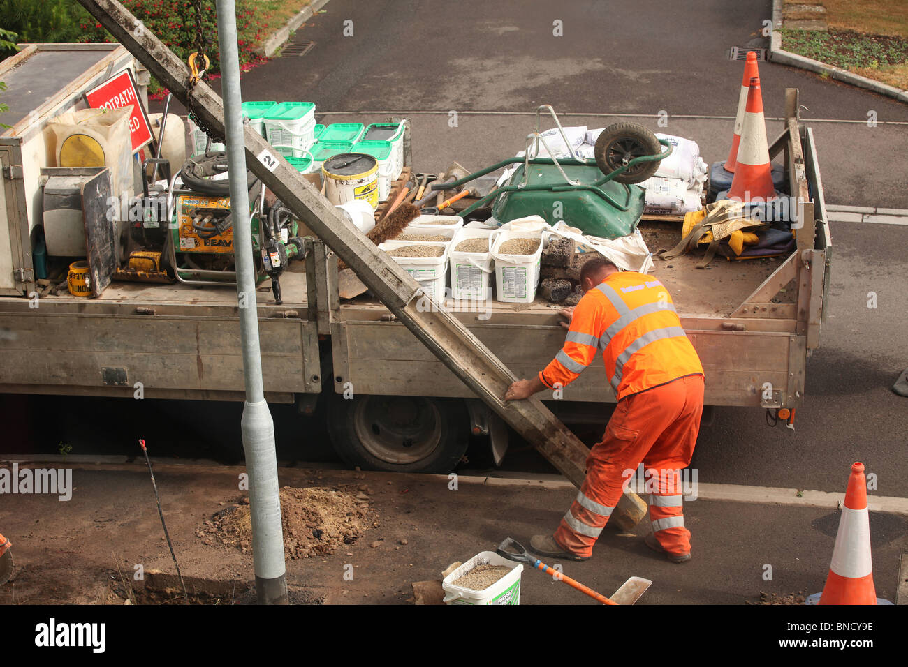 Two men from the council replacing a lamp post Stock Photo - Alamy