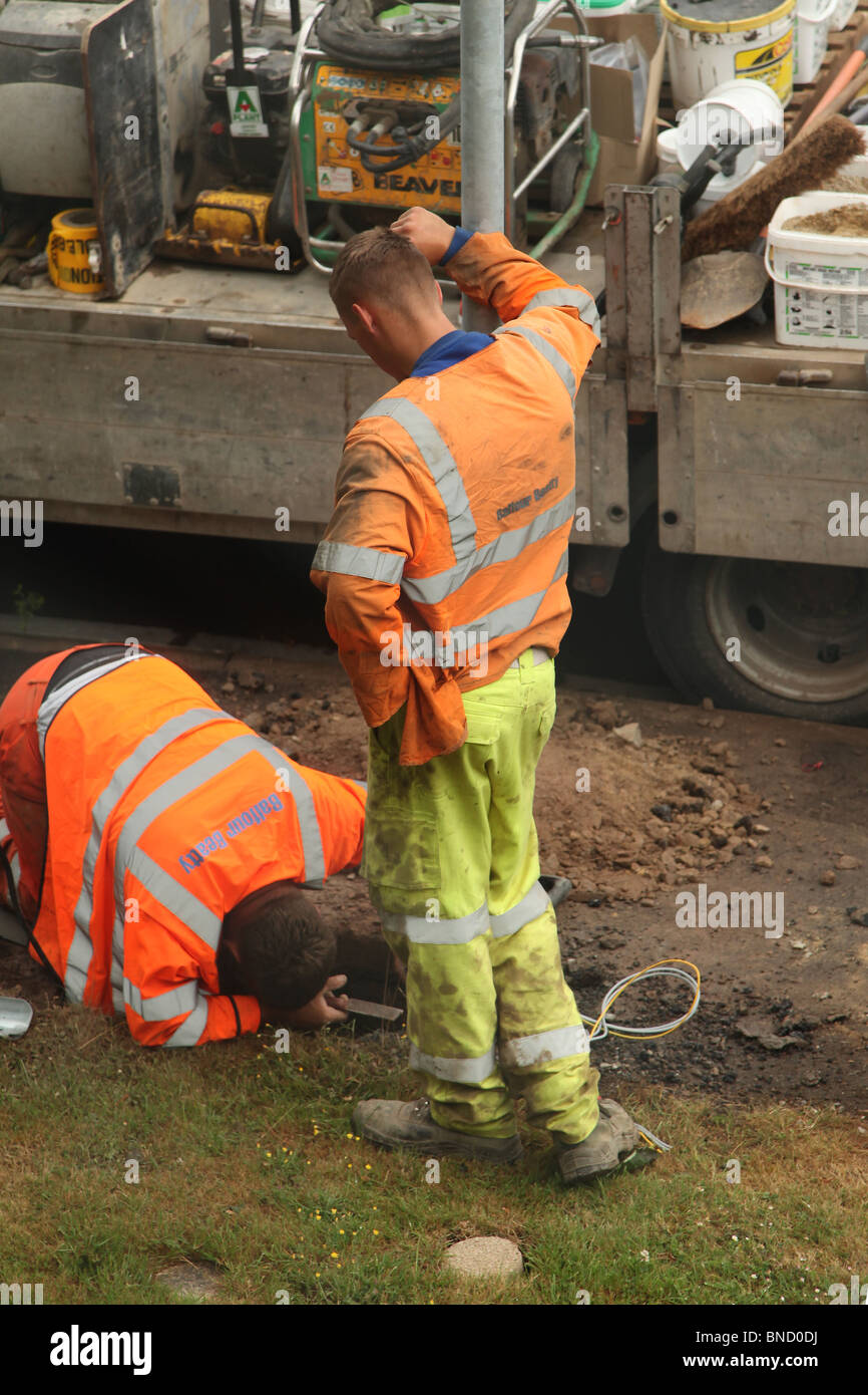 Two men from the council replacing a lamp post Stock Photo - Alamy