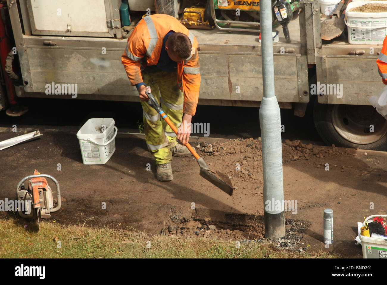 Two men from the council replacing a lamp post Stock Photo - Alamy