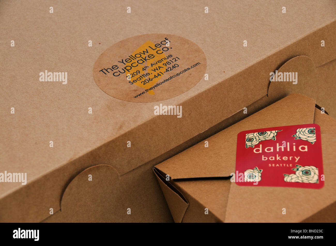 Brown bakery boxes closed and ready to go with bakery stickers attached ...