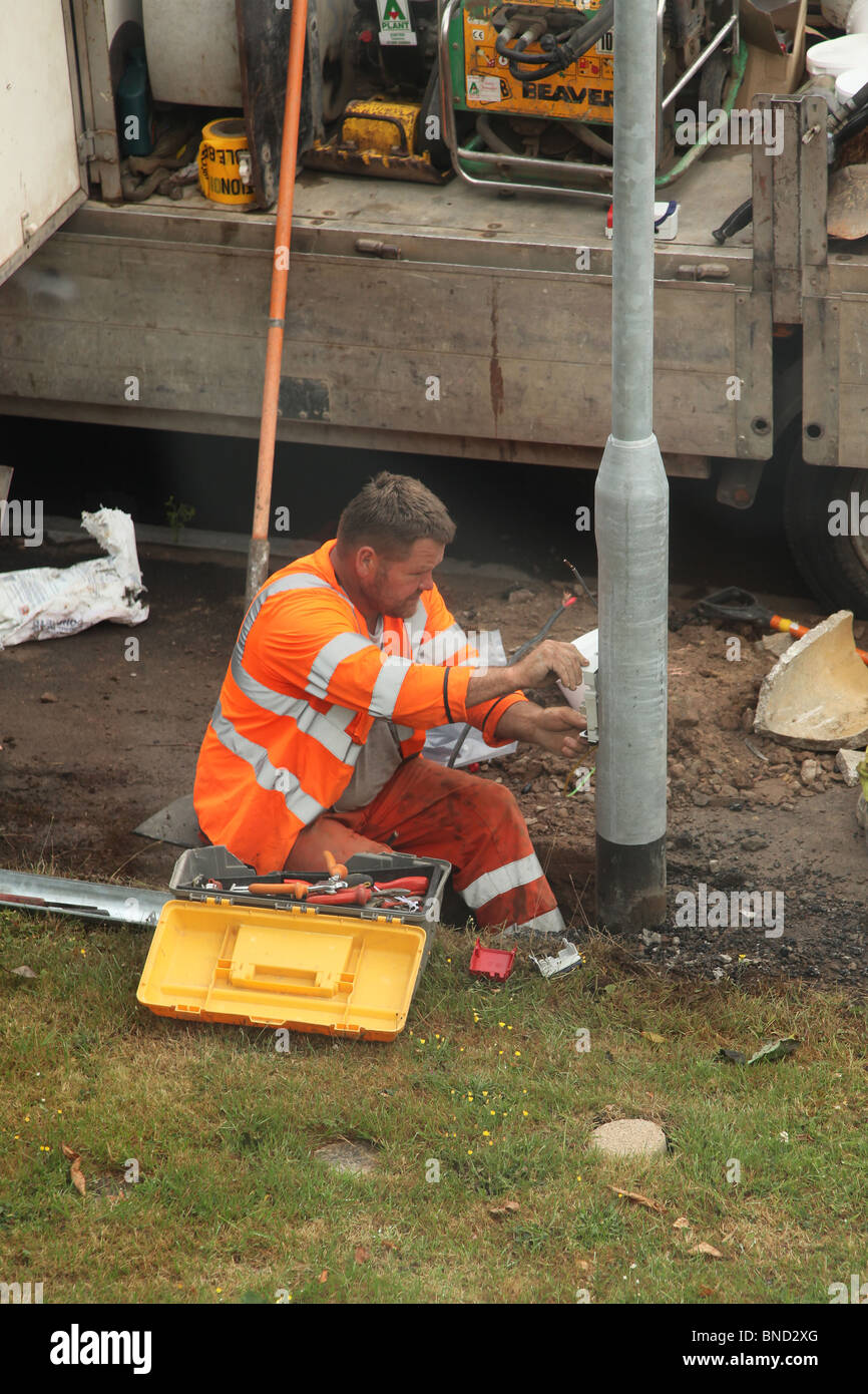 Two men from the council replacing a lamp post Stock Photo - Alamy