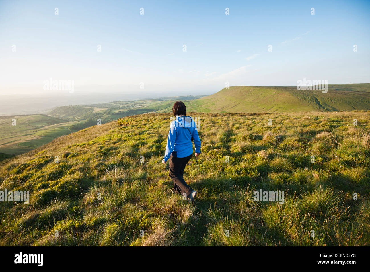 SIngle hiker near ridge on Twmpa with Hay Bluff in background, Black ...