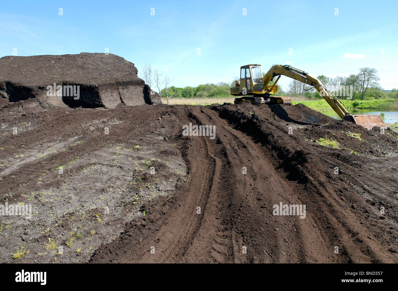 Peat cutting operation taking place on the Somerset levels with a large ...