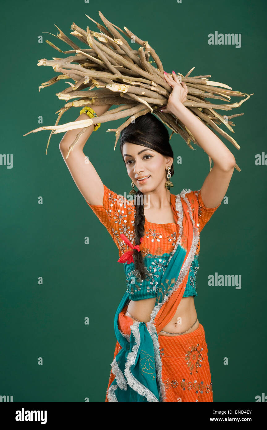 Woman carrying a bundle of firewood on her head Stock Photo - Alamy