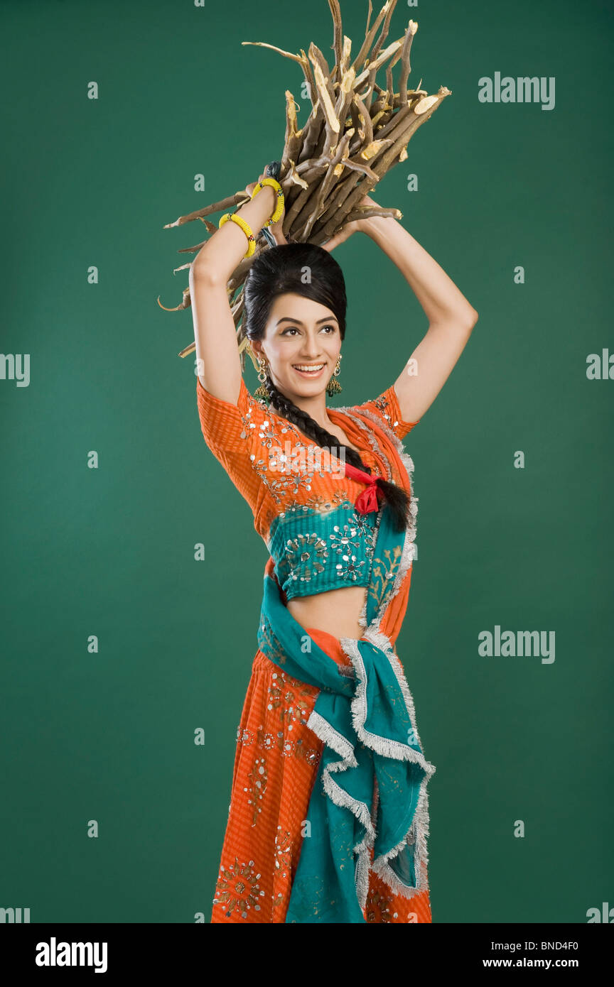 Woman carrying a bundle of firewood on her head Stock Photo - Alamy