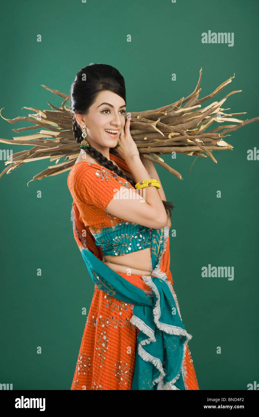 Woman carrying a bundle of firewood on her shoulder Stock Photo - Alamy