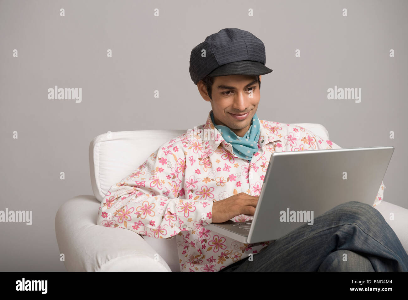 Actor portraying Dev Anand and using a laptop Stock Photo - Alamy