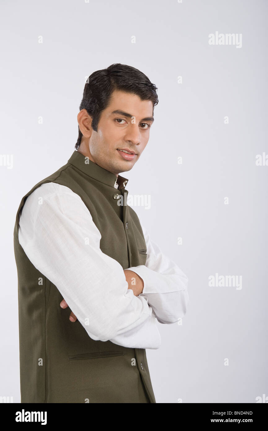 Portrait of an actor portraying a politician standing with arms crossed ...