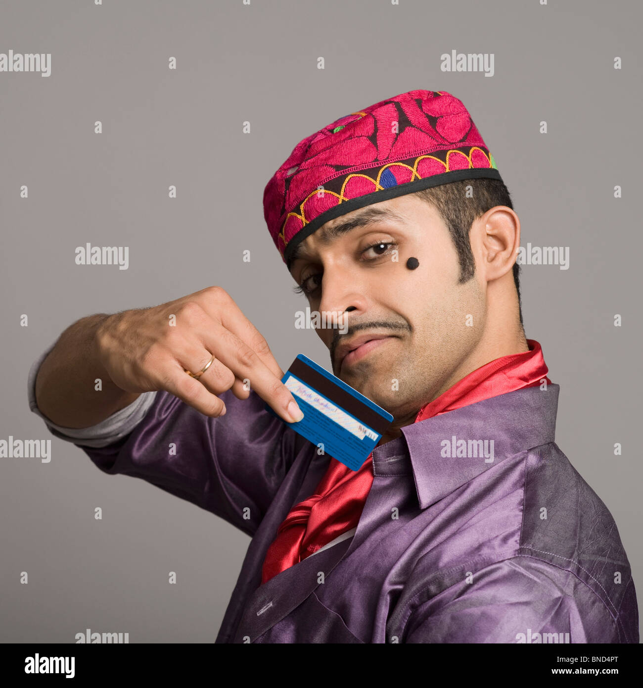 Portrait of an actor portraying a tapori holding a credit card Stock ...