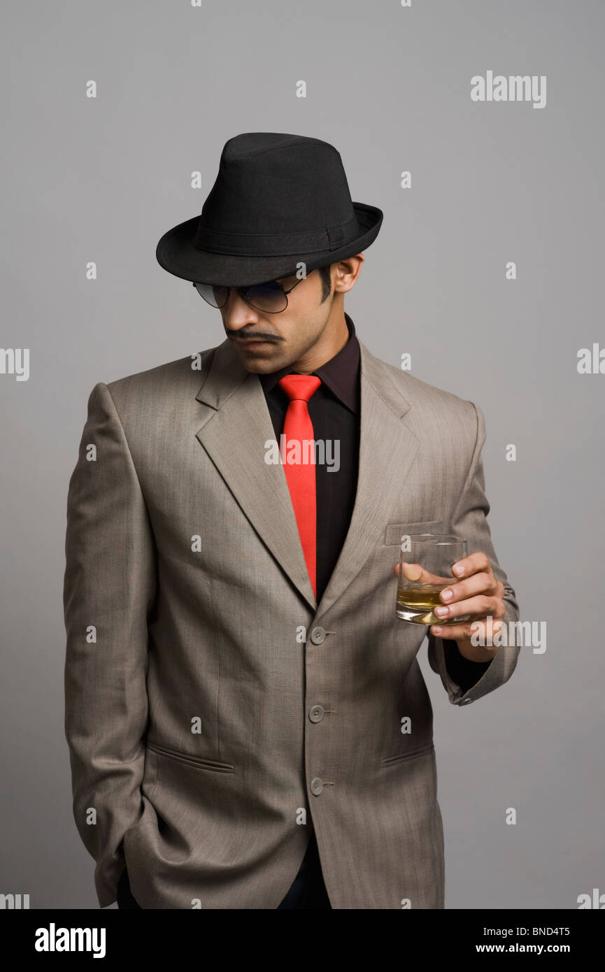 Actor portraying a businessman holding a wineglass Stock Photo - Alamy