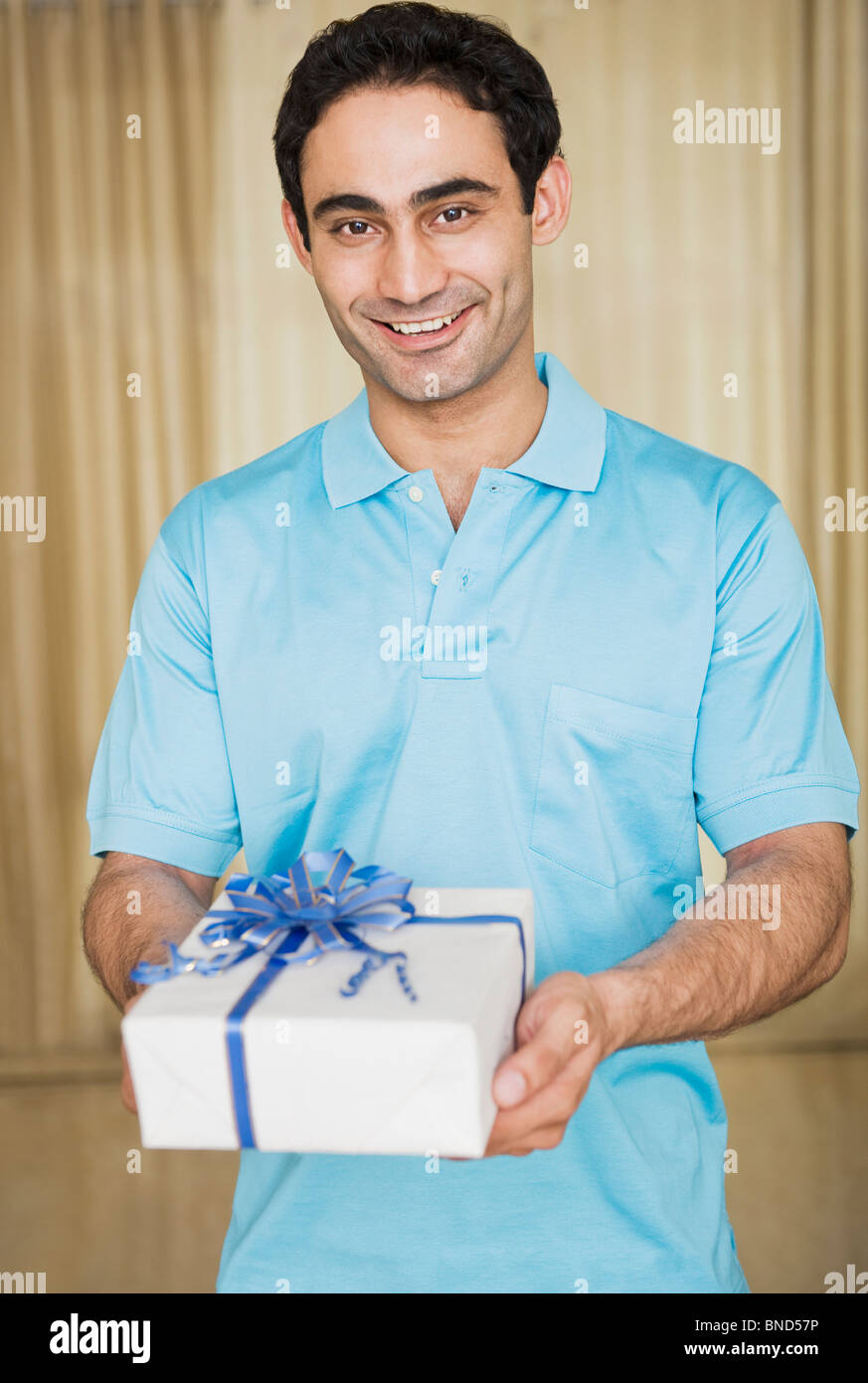 Portrait of a man holding a birthday present Stock Photo - Alamy
