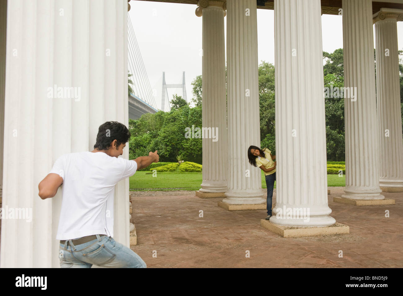 Couple playing hide and seek at James Prinsep Memorial with bridge in ...