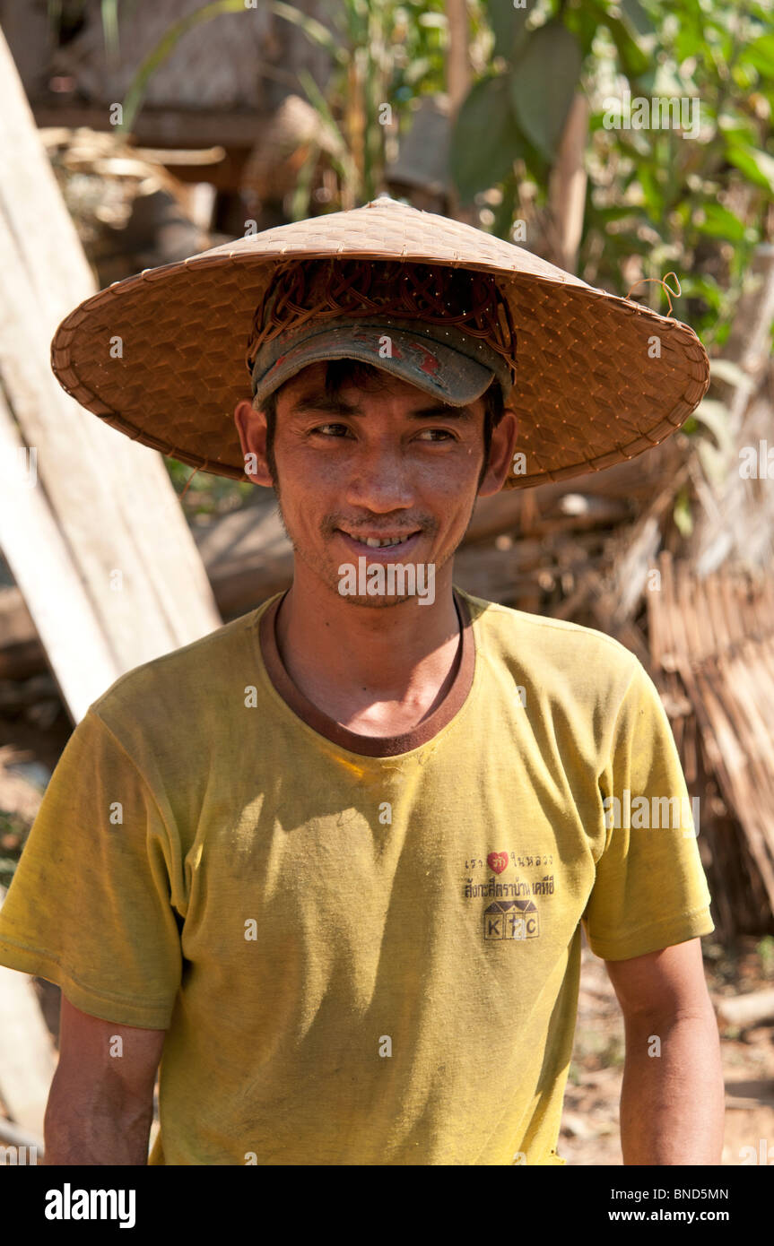 A Lao man wearing a conical hat in a tribal village Northern Laos Stock ...