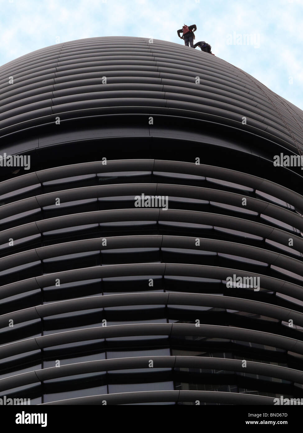 Workers stand on top of the Walbrook offices of Vanguard Asset ...