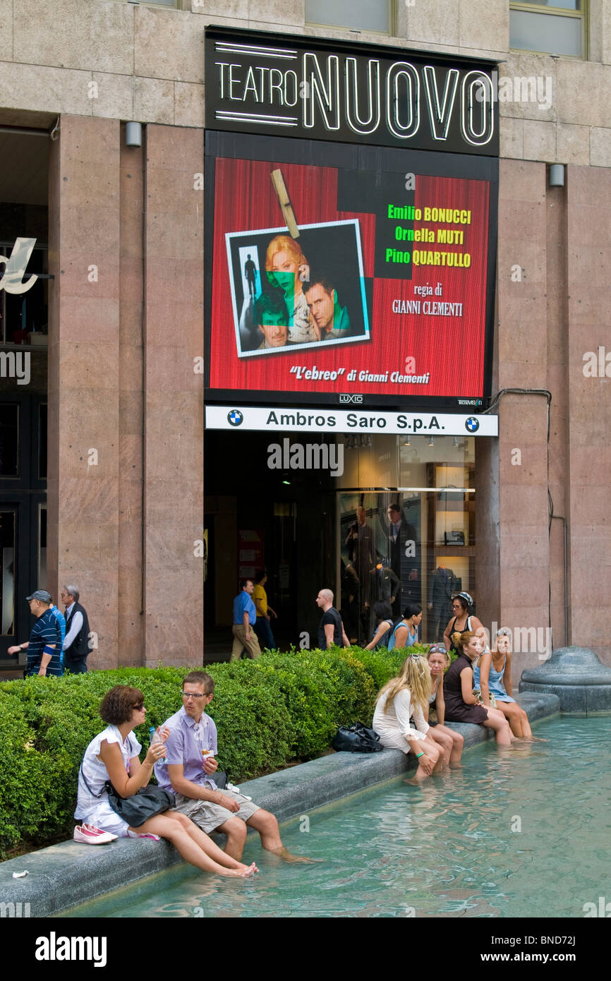 Cooling in the fountain, San Babila square, Milan, Italy Stock Photo ...