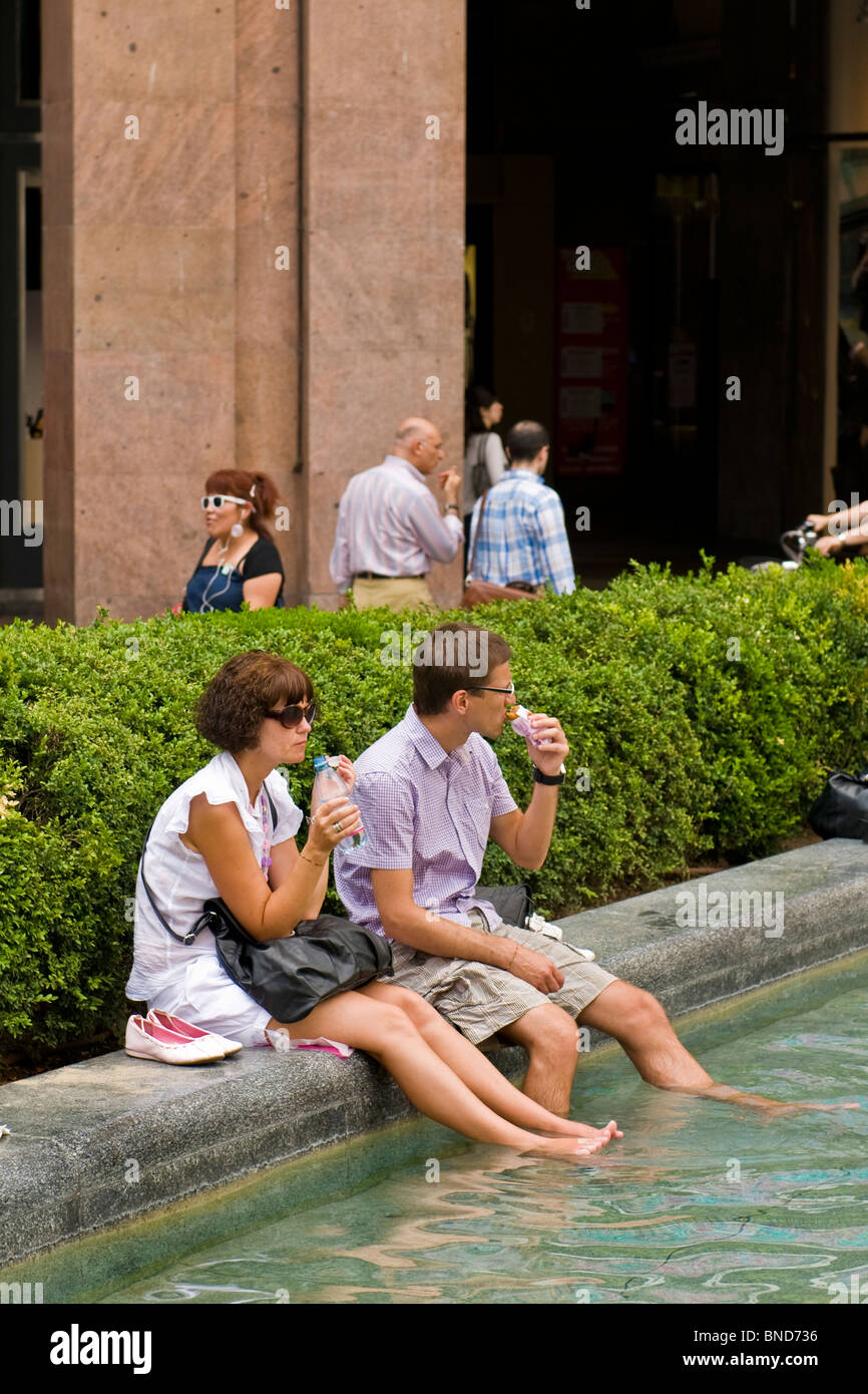 Cooling in the fountain, San Babila square, Milan, Italy Stock Photo ...