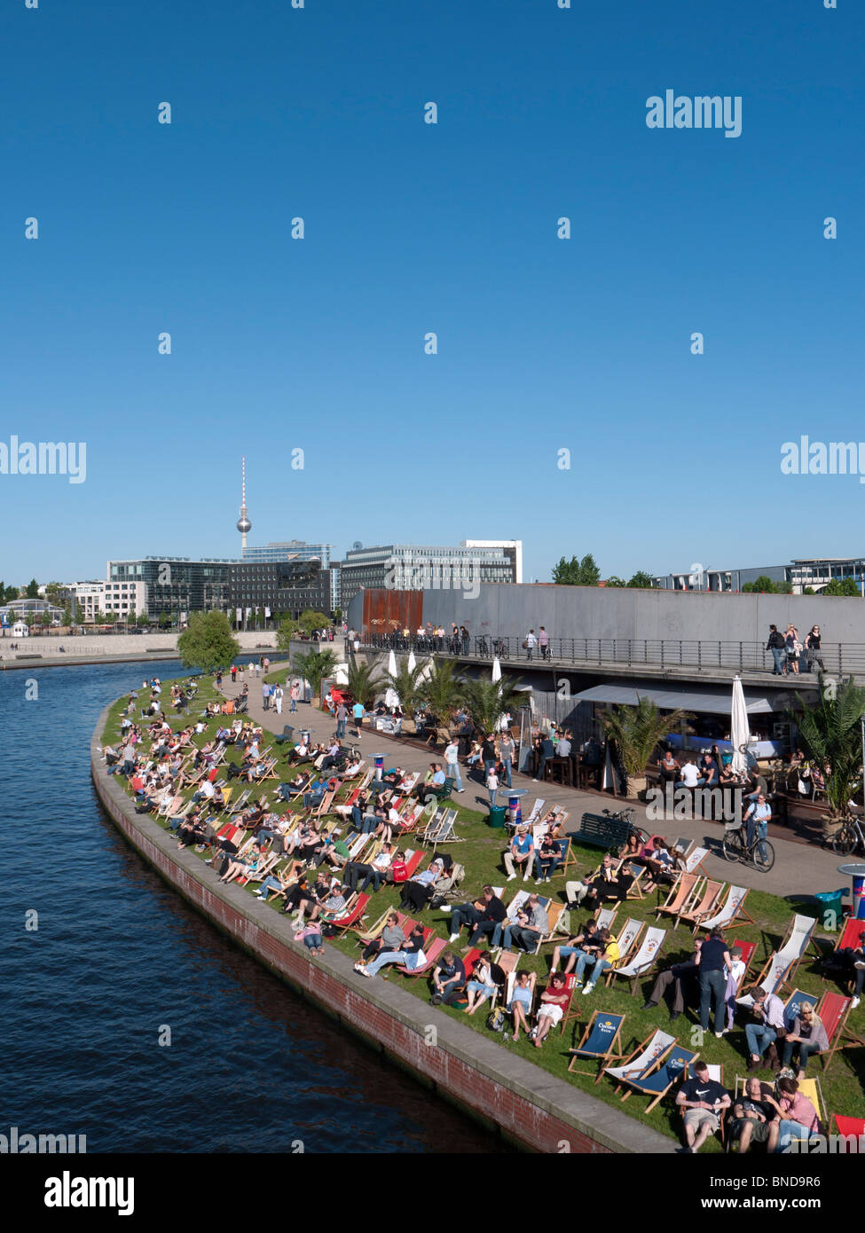 Busy waterside cafe in summer beside Spree River in central Mitte ...