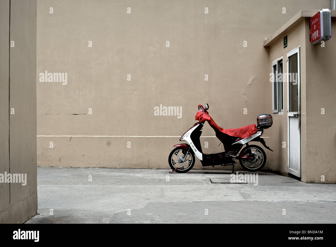 A red electric scooter in a clean back alley in Shanghai China Stock ...