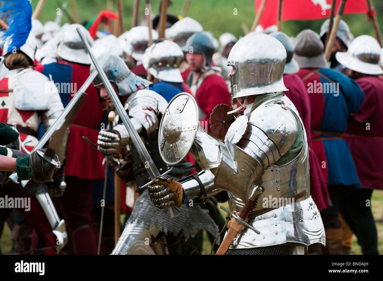 Knights in armor fighting on the battlefield at the re-enactment of the ...