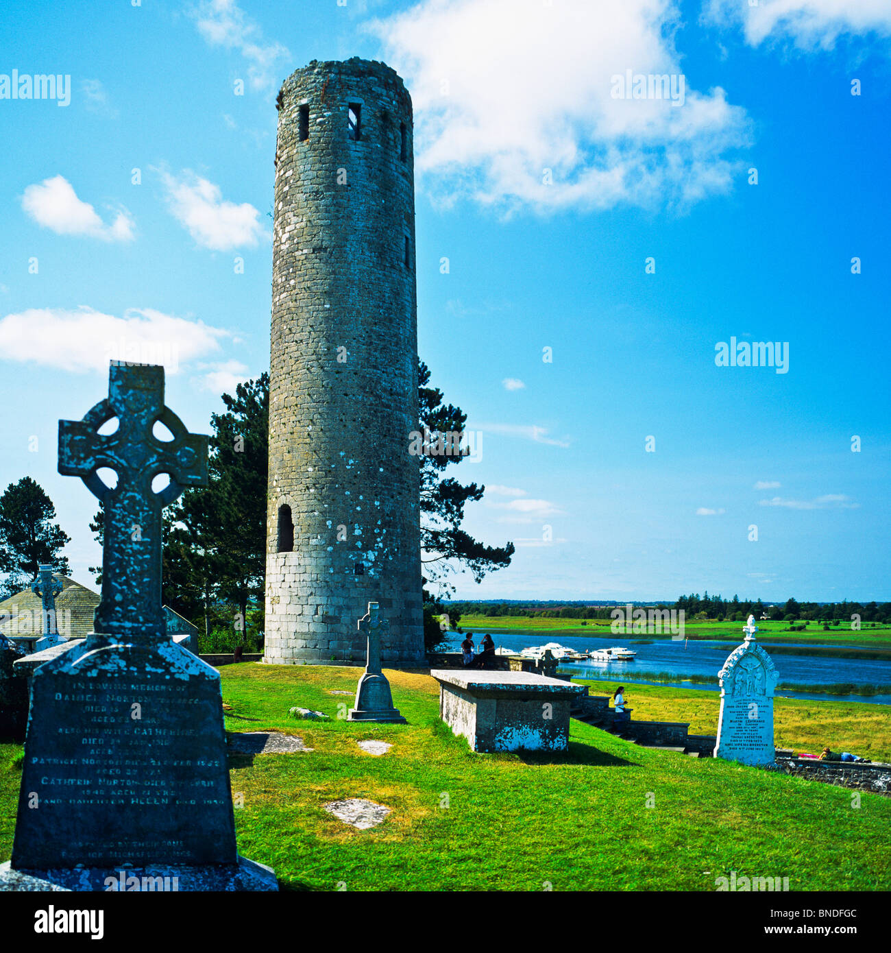 Graveyard with "Rourke's" round tower, Clonmacnoise monastery, County ...