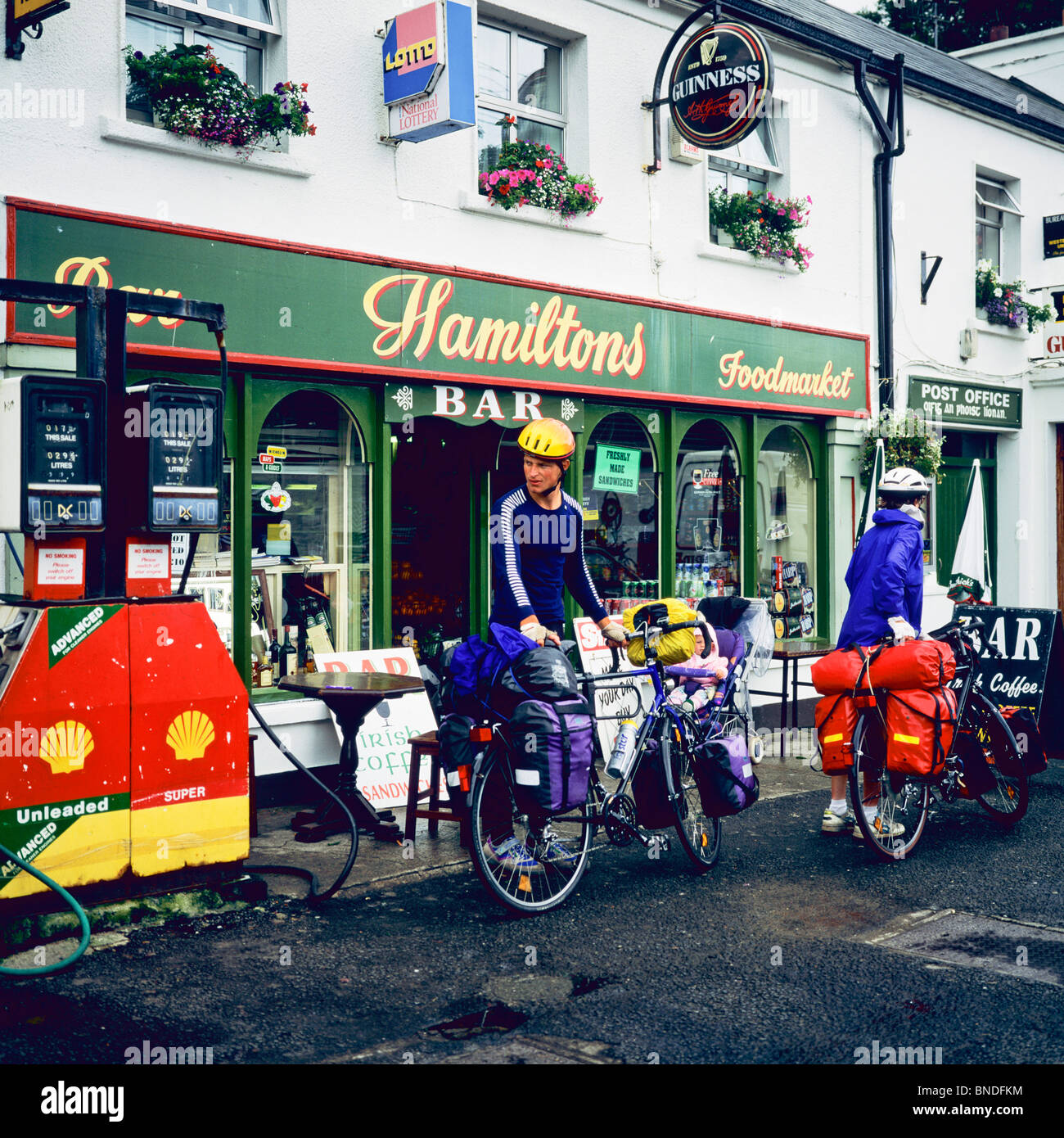 Touring bikers by "Hamiltons" bar and foodmarket, Leenane, Connemara ...