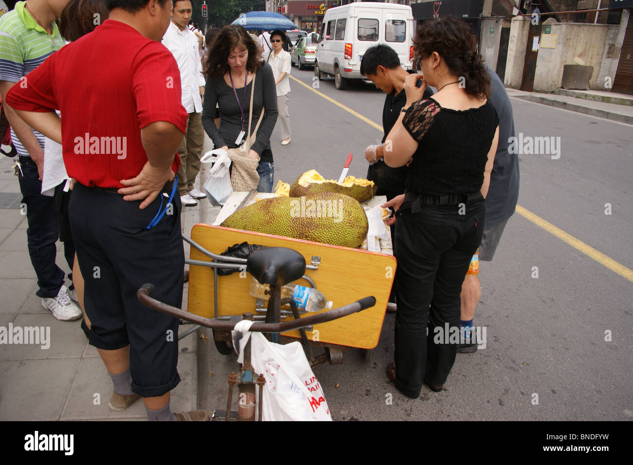 Street vendor selling melon from a bicycle trailer, Shanghai, China ...