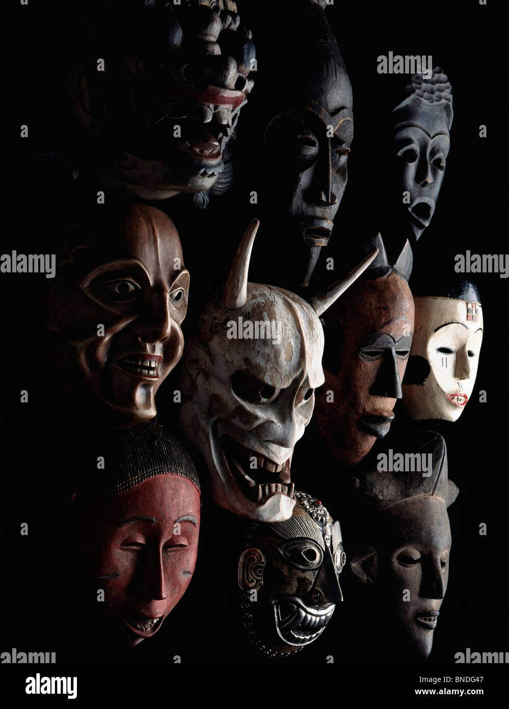 Face masks on black wall Stock Photo - Alamy