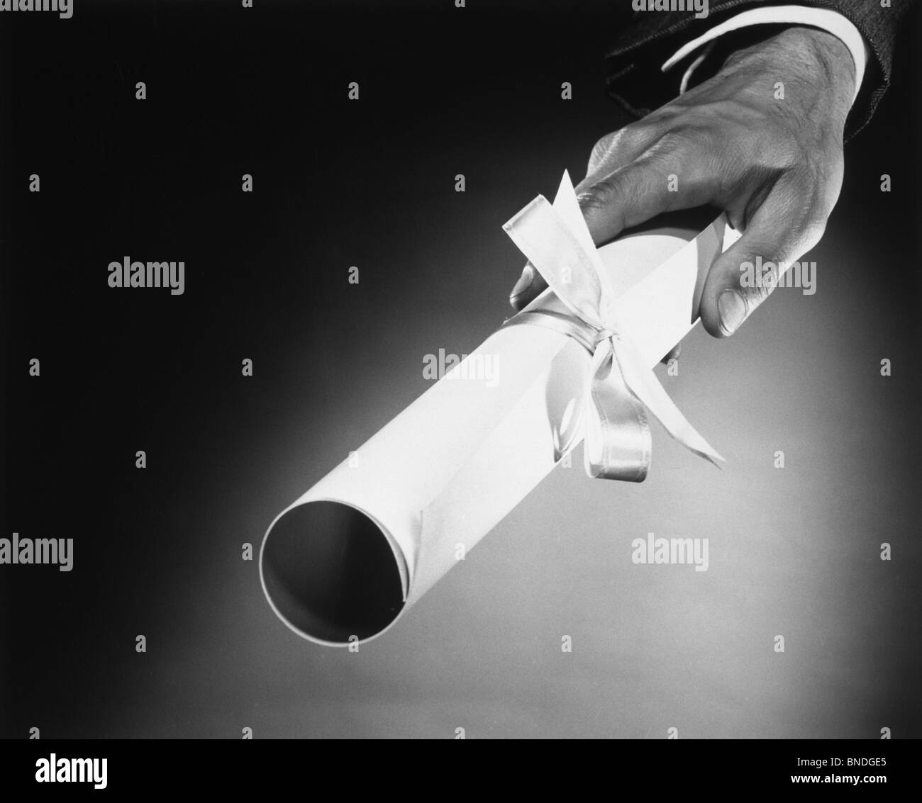 Close-up of a man's hand holding a diploma Stock Photo - Alamy