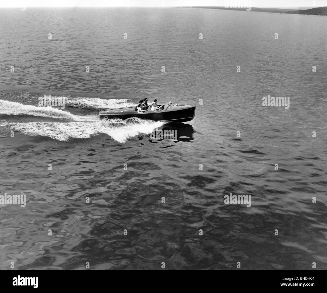 High angle view of four people in a motorboat Stock Photo - Alamy