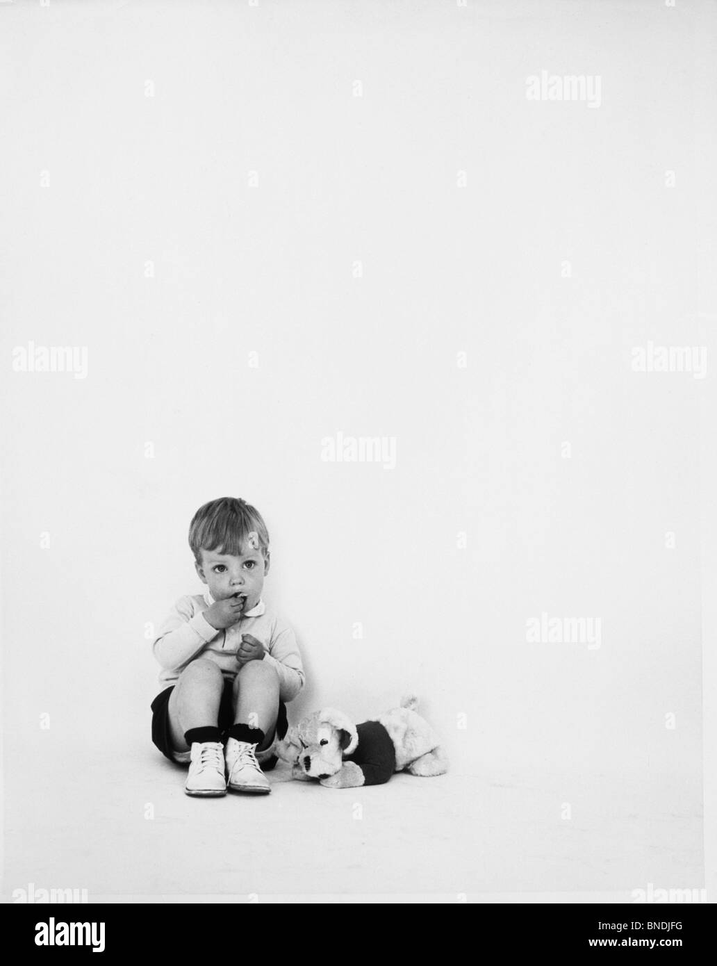 Baby boy looking sad Stock Photo - Alamy