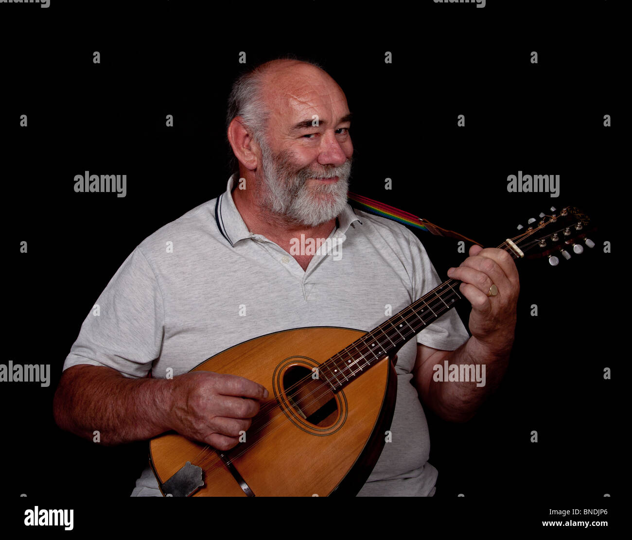 Bearded musician plays octave mandola, smiling Stock Photo - Alamy