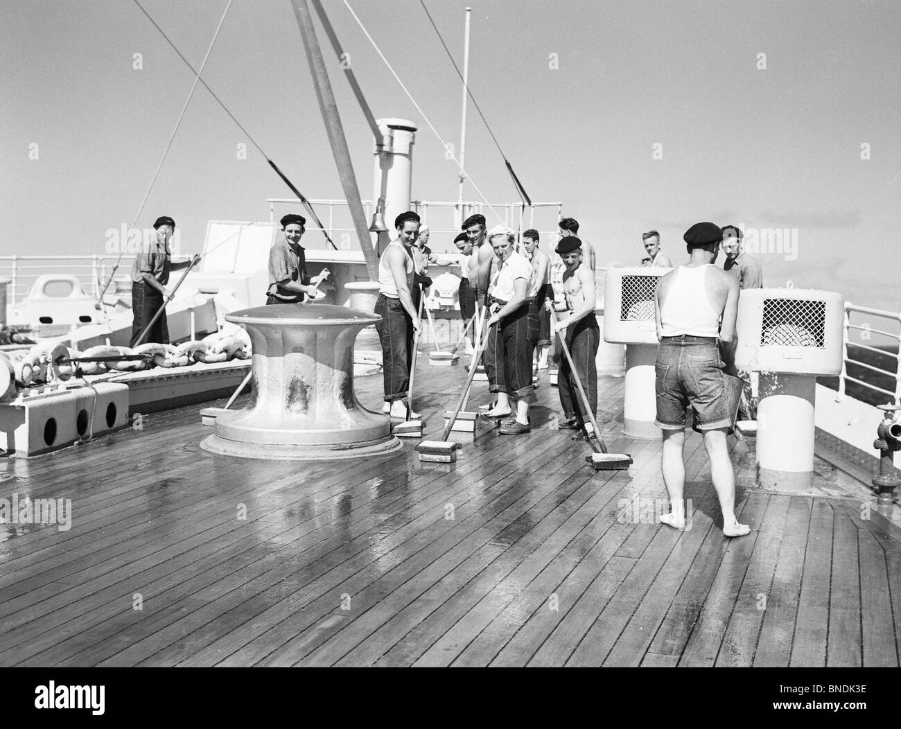Group of people cleaning the deck of a ship Stock Photo - Alamy
