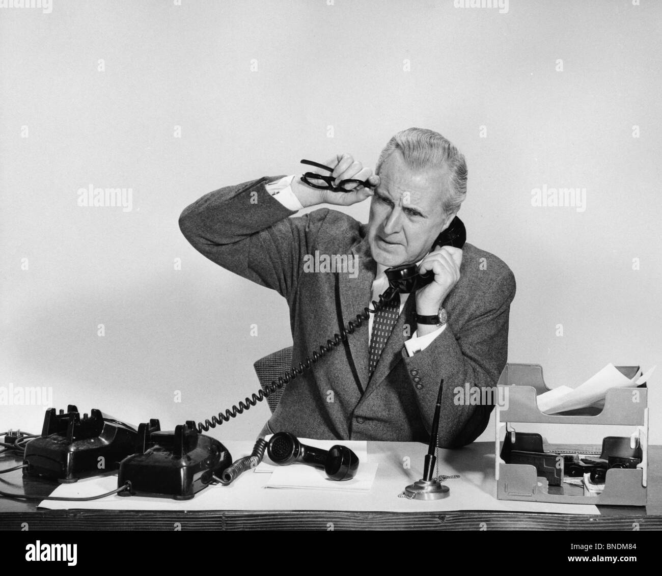 Serious talking phone business Black and White Stock Photos & Images ...