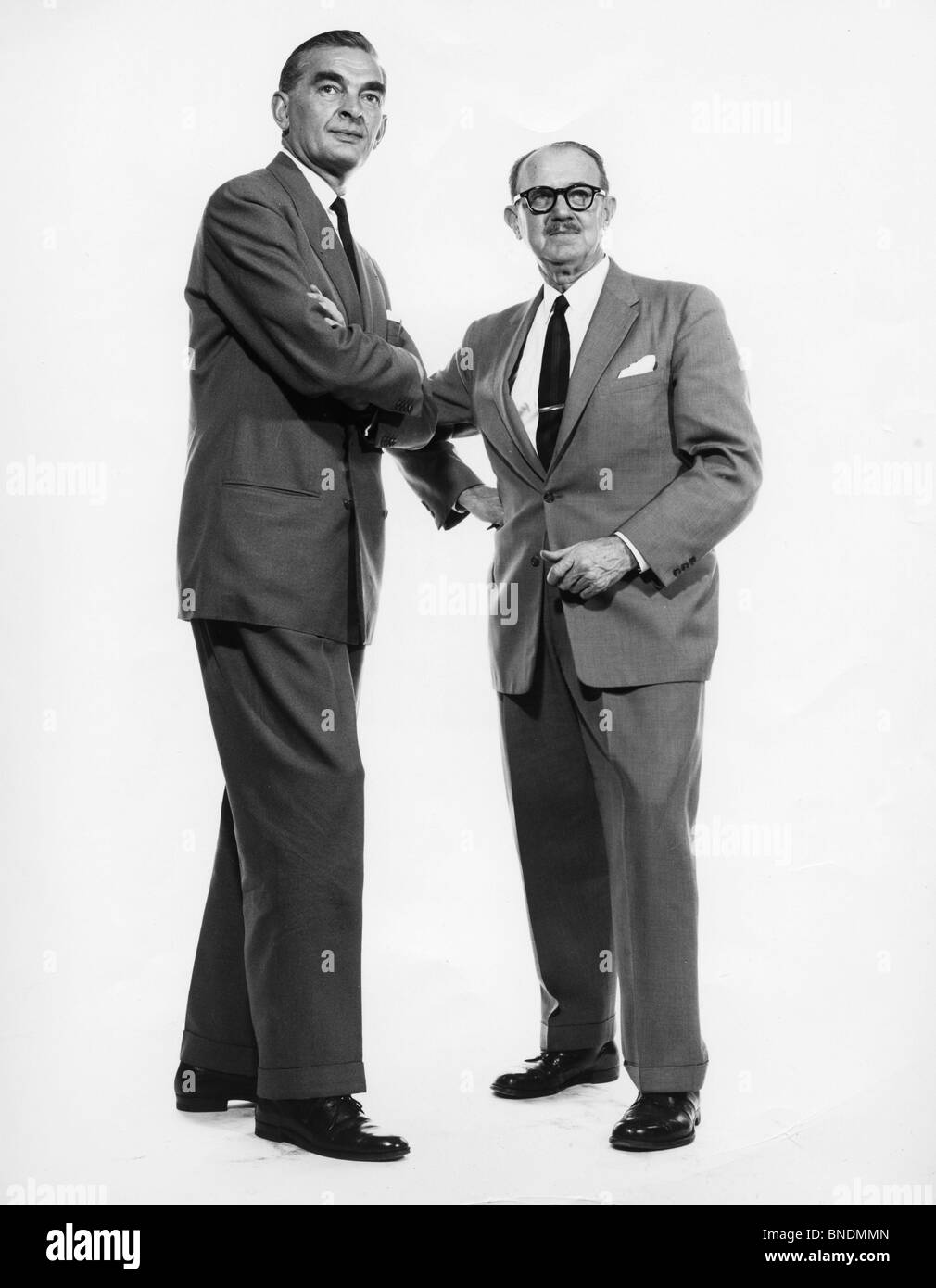Two men standing side by side Black and White Stock Photos & Images - Alamy