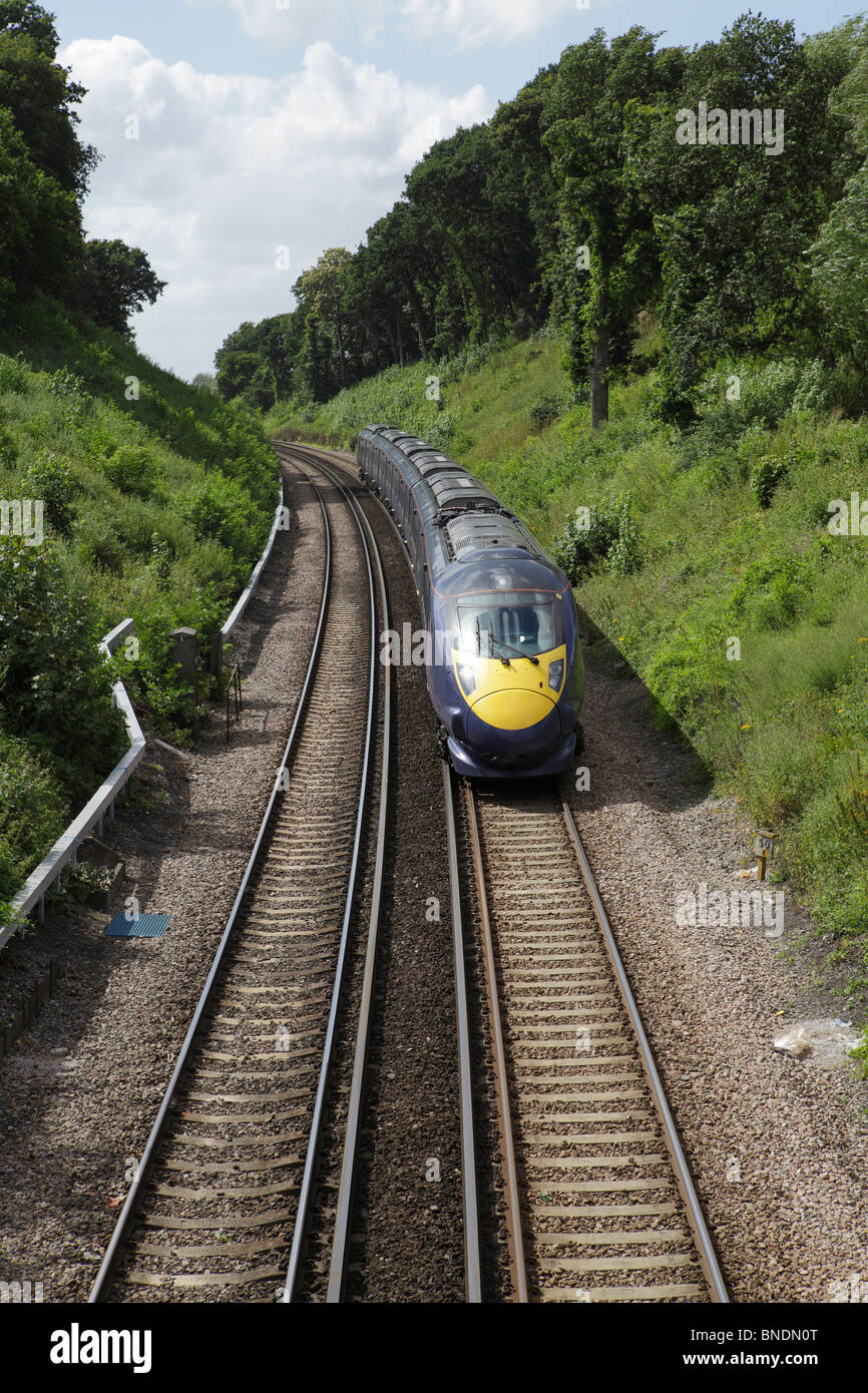 A train rushing through the Kent countryside Stock Photo - Alamy