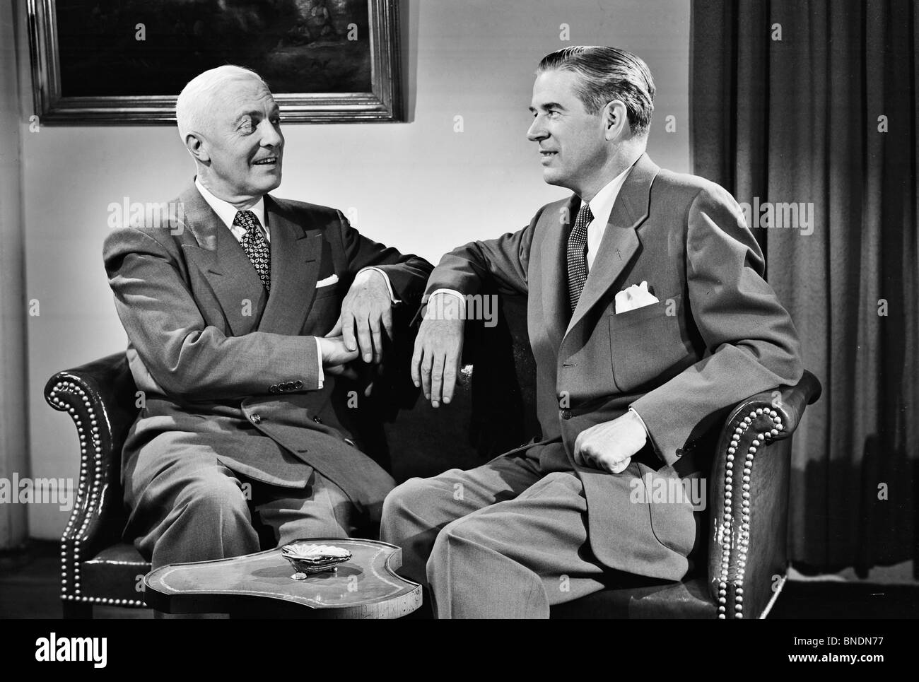 Two businessmen talking to each other Stock Photo - Alamy