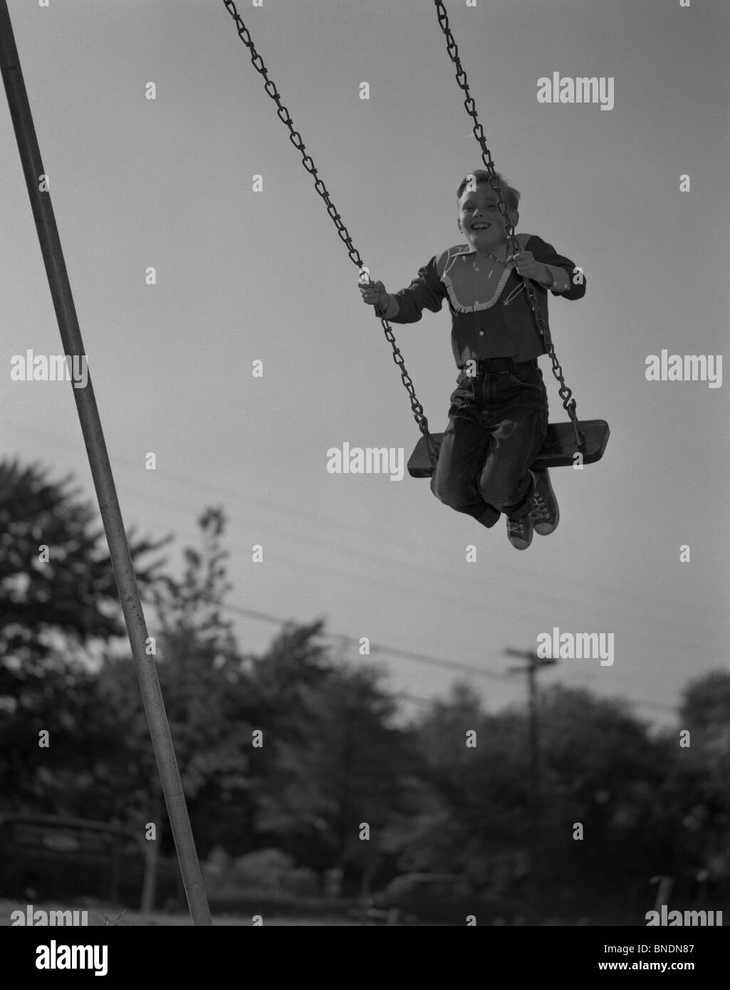 Swinging on a swing Black and White Stock Photos & Images - Alamy