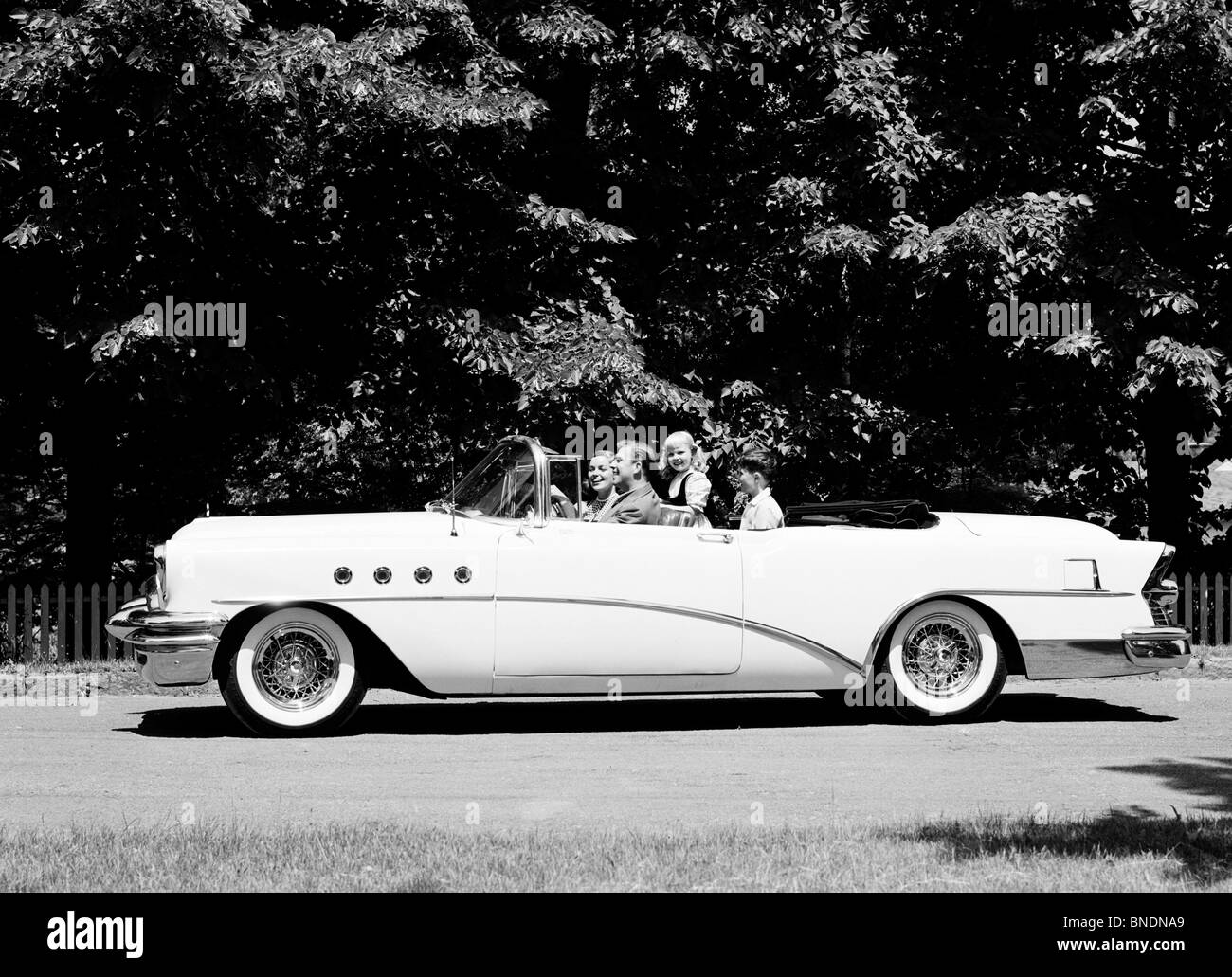 Side profile of parents and their two children traveling in a car Stock ...