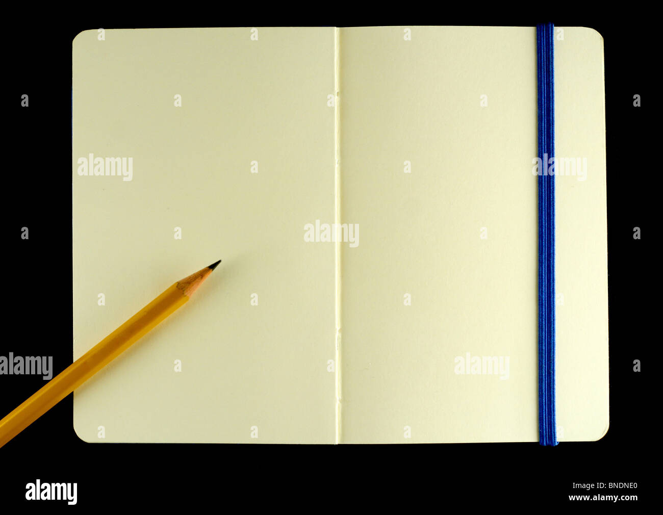 Classic opened moleskine note book with pencil isolated on black ...