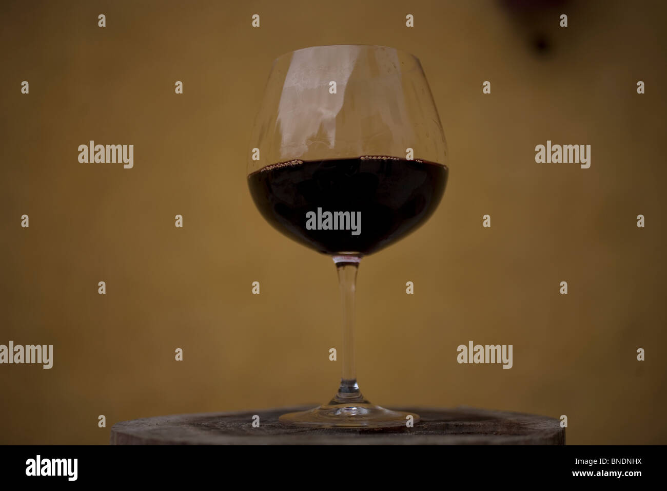 A glass of red wine sits in Taramilla winery in Prado del Rey, Cadiz ...